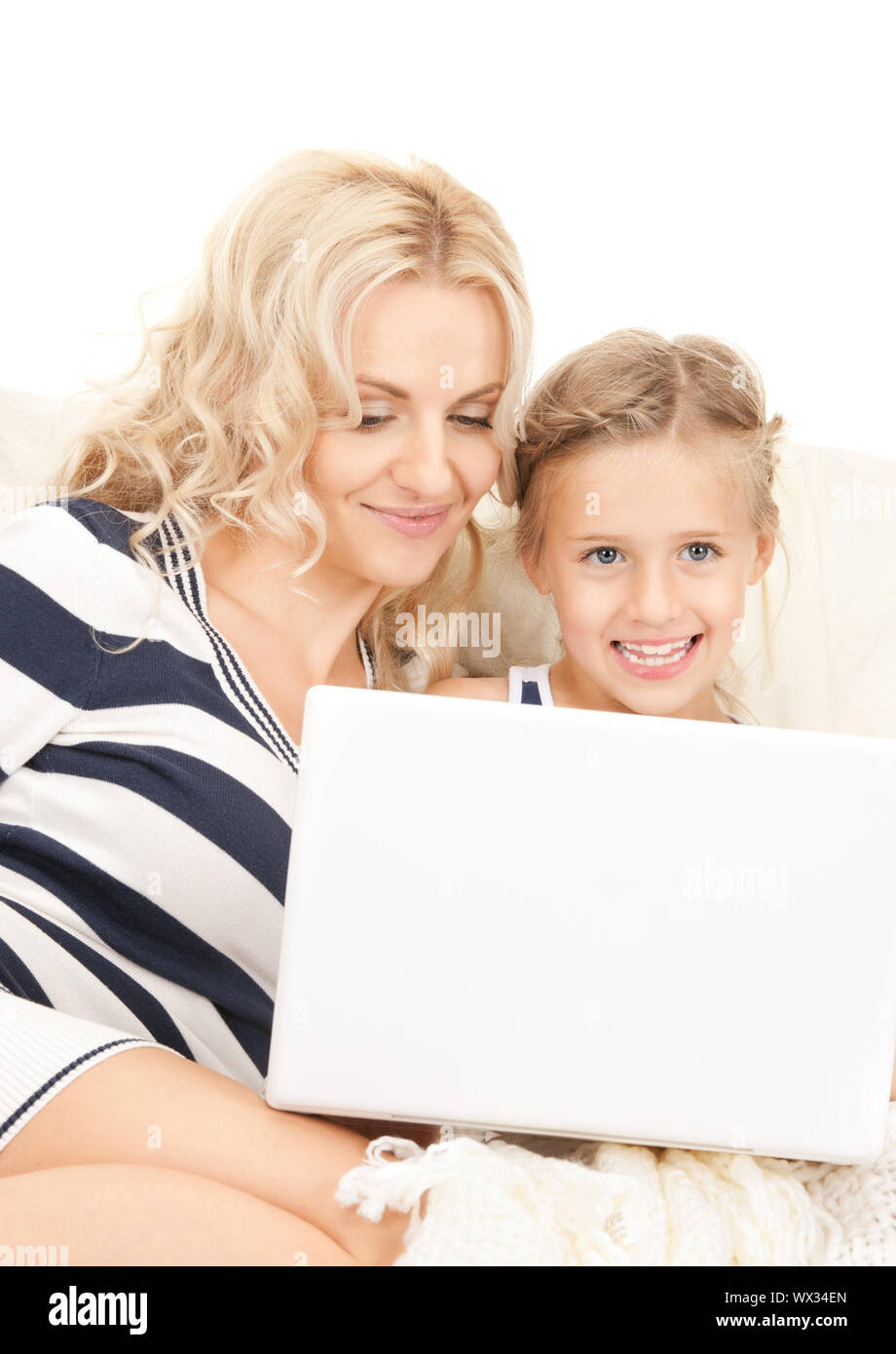 bright picture of happy mother and child with laptop computer (focus on ...