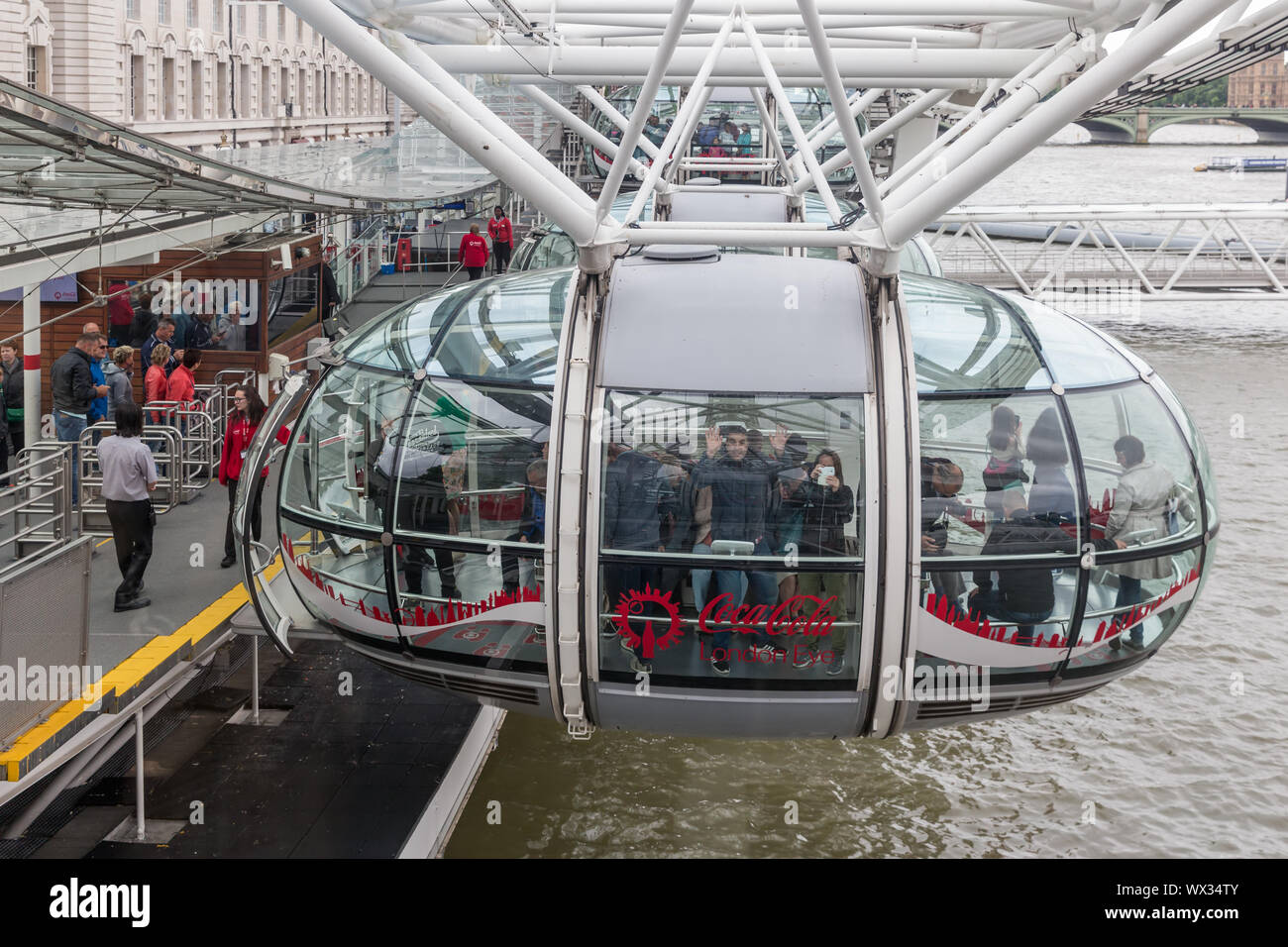 Tourists entering a cabin of London Eye in London, England Stock Photo ...