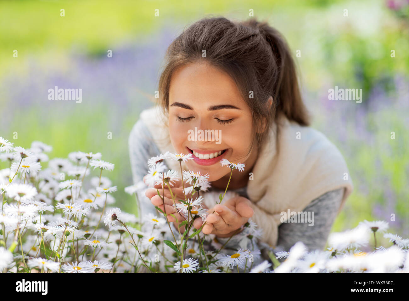 close up of woman smelling chamomile flowers Stock Photo - Alamy