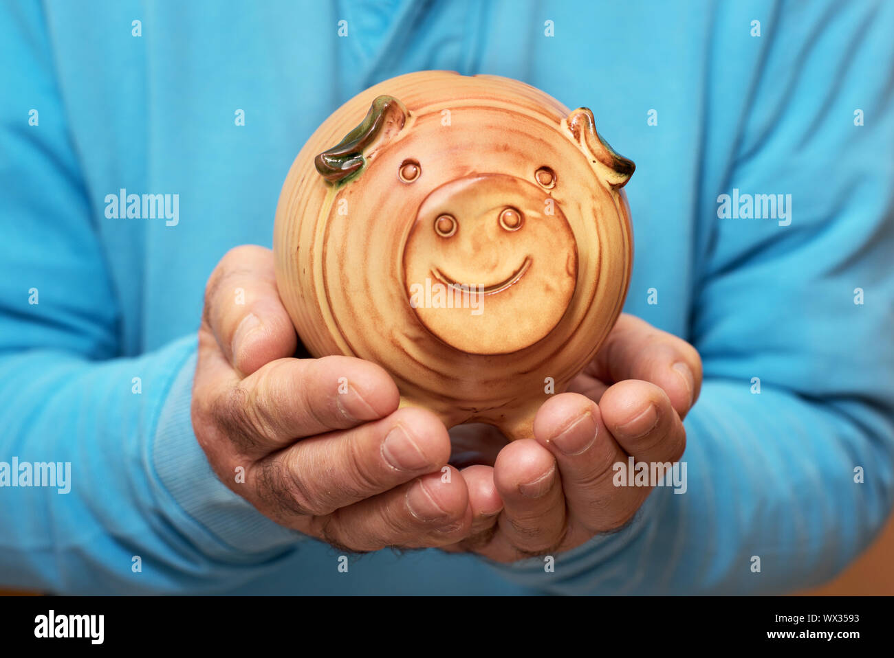 Elderly hands holding piggy bank hi-res stock photography and images ...