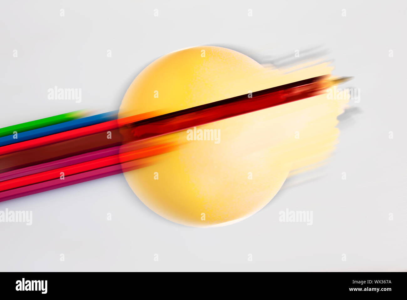 Yellow ball on the move with a trail of beautiful rainbow colors ...