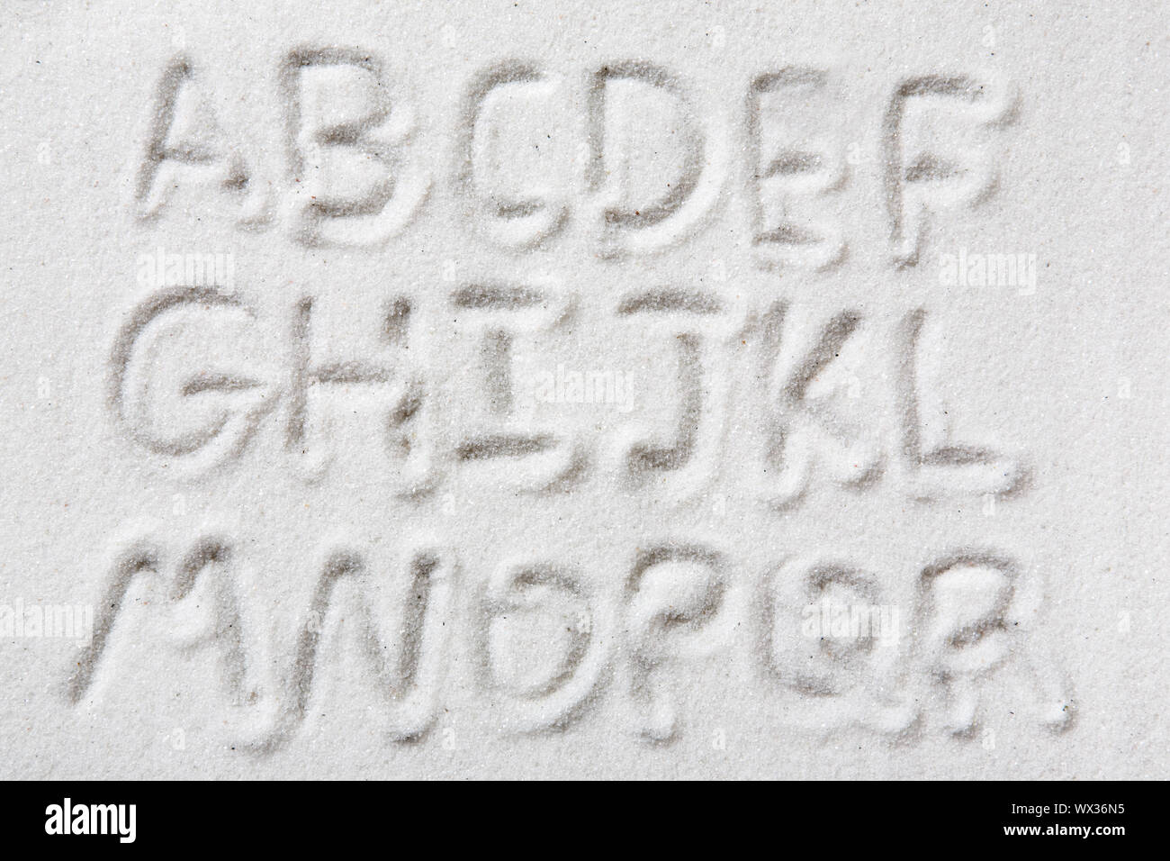 First half of an upper case alphabet written in sand - a designers tool ...