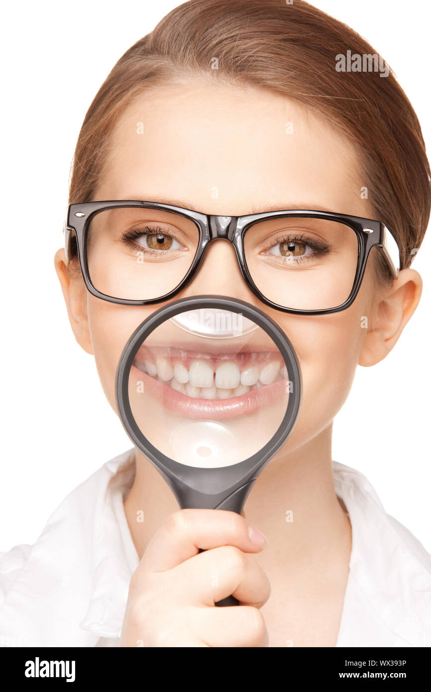 woman with magnifying glass showing teeth Stock Photo - Alamy