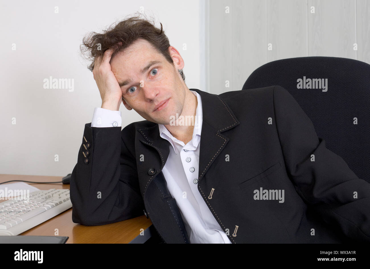 The sorrowful man at the office, on a workplace Stock Photo - Alamy