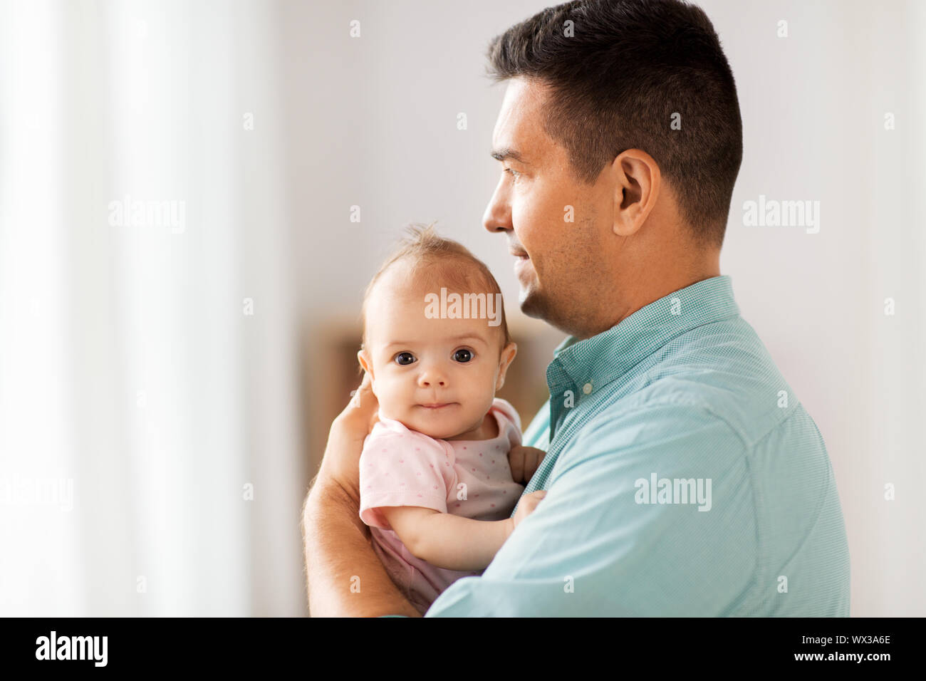 middle aged father with baby daughter at home Stock Photo - Alamy