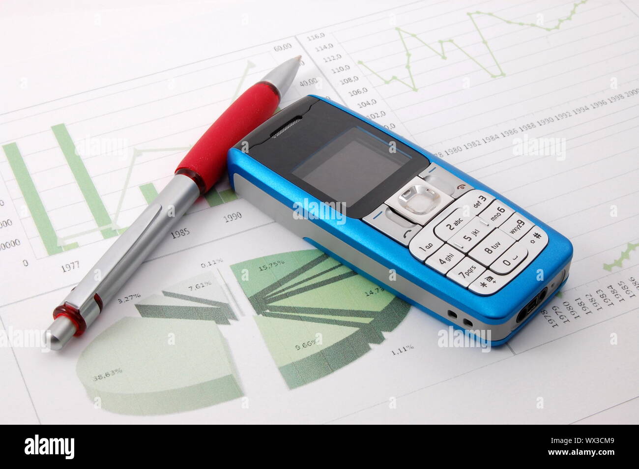 blue cell phone over business chart showing success Stock Photo - Alamy
