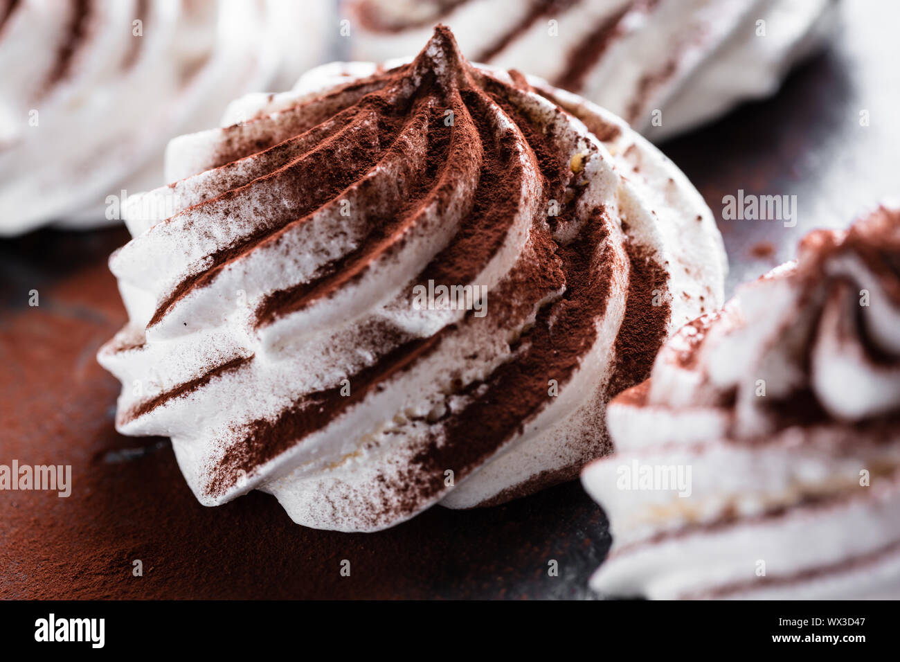 White meringue with cocoa powder Stock Photo - Alamy