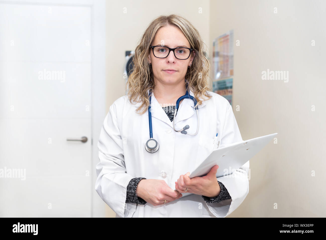 Portrait of a female doctor holding her patient chart Stock Photo - Alamy