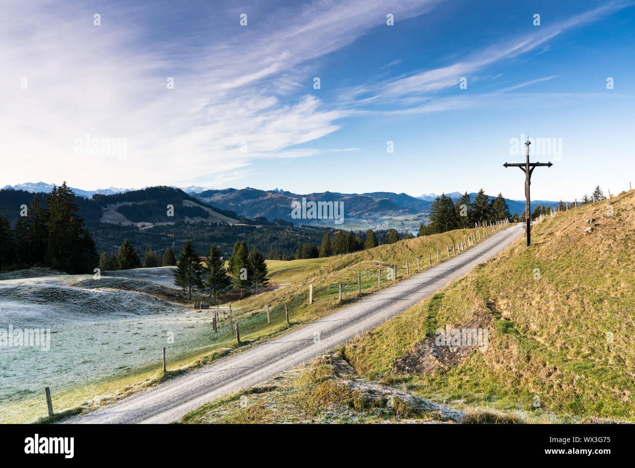 open country landscape with grassy meadow and road and rime and ice and ...