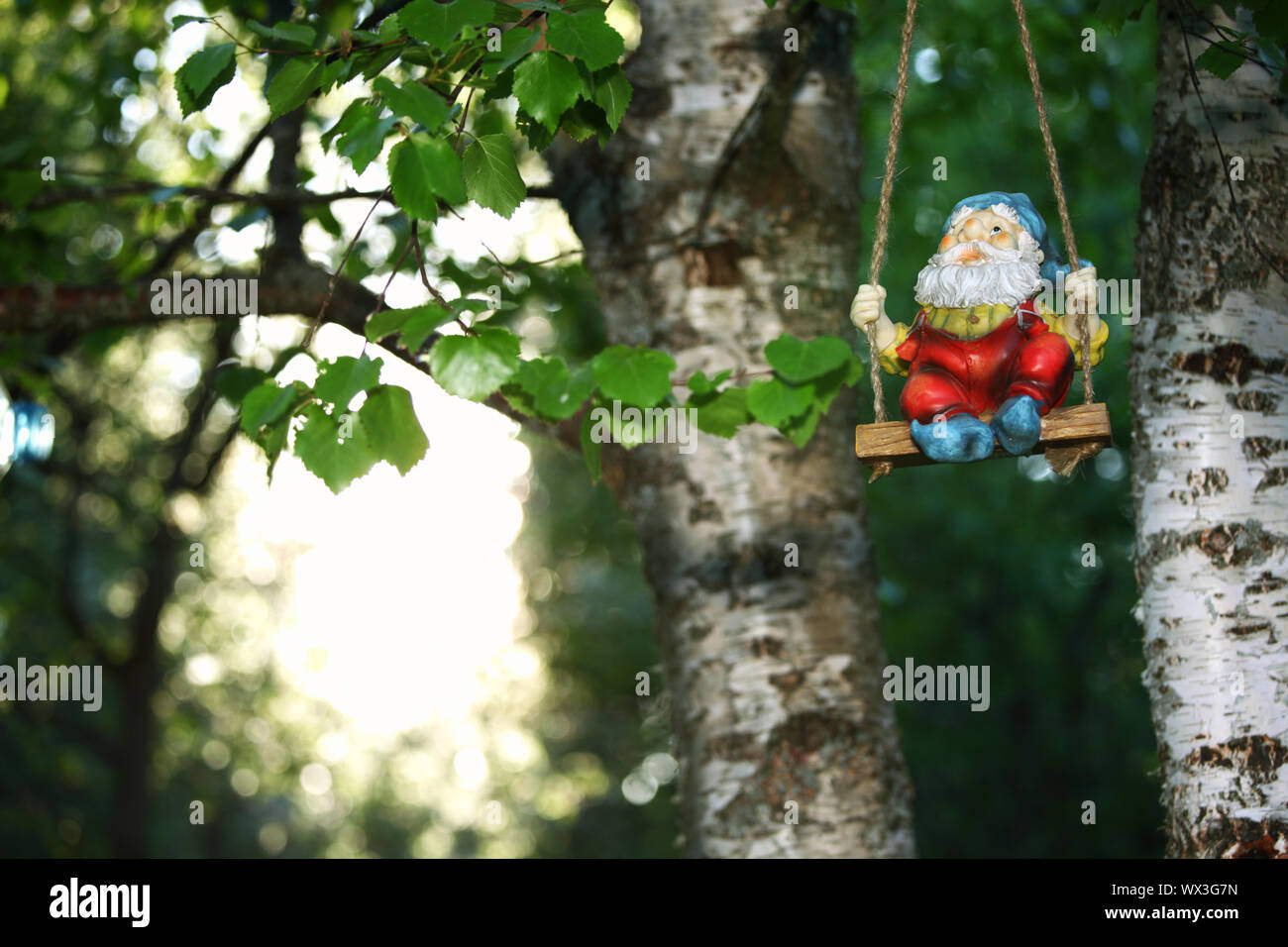 garden dwarf on green nature background Stock Photo - Alamy