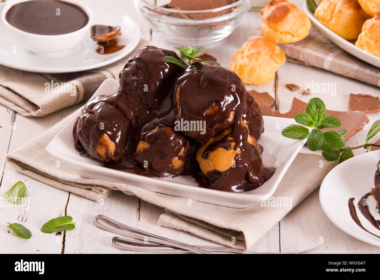 Chocolate profiteroles with chantilly cream hi-res stock photography ...