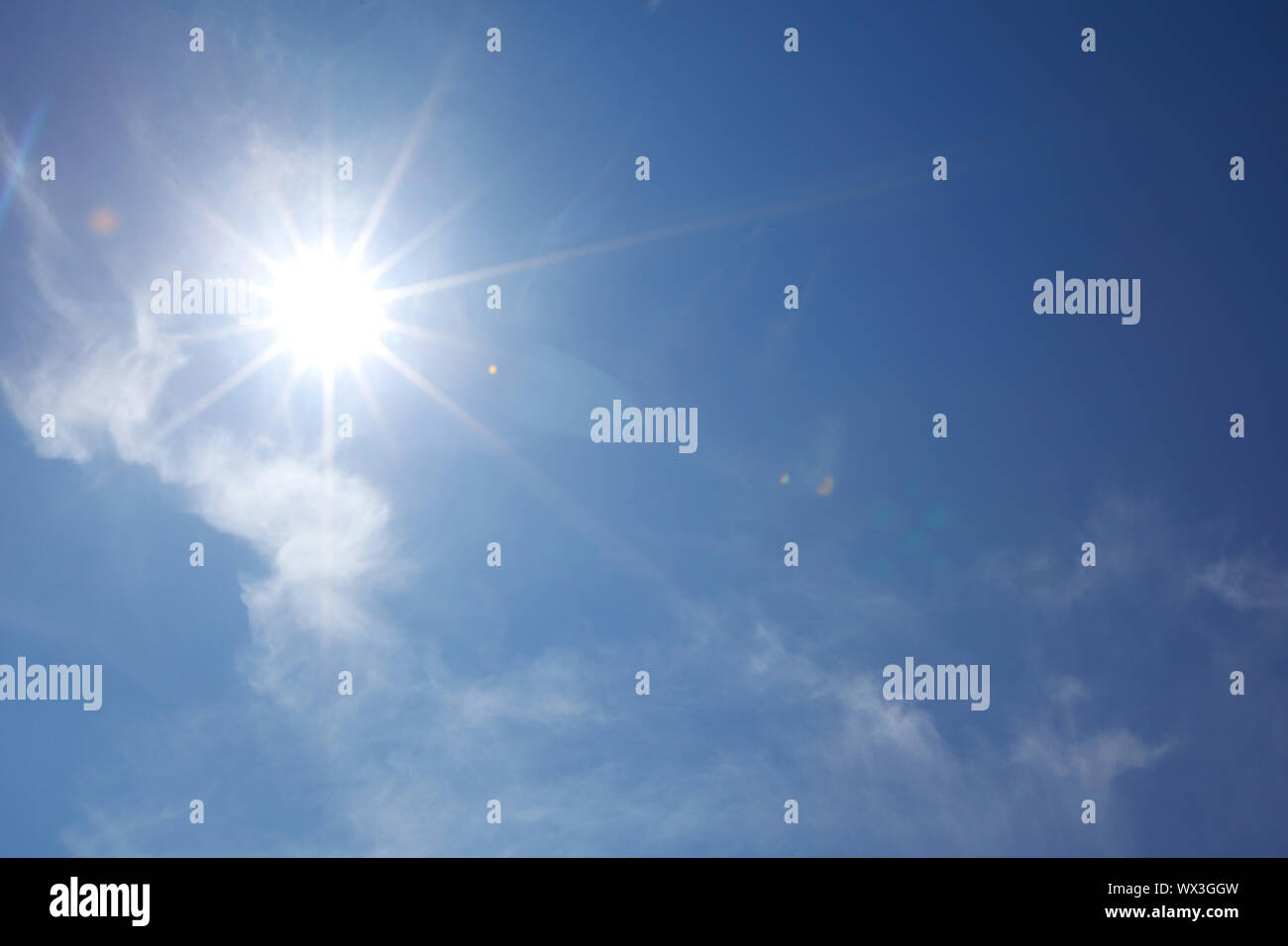 sun in blue day sky Stock Photo - Alamy