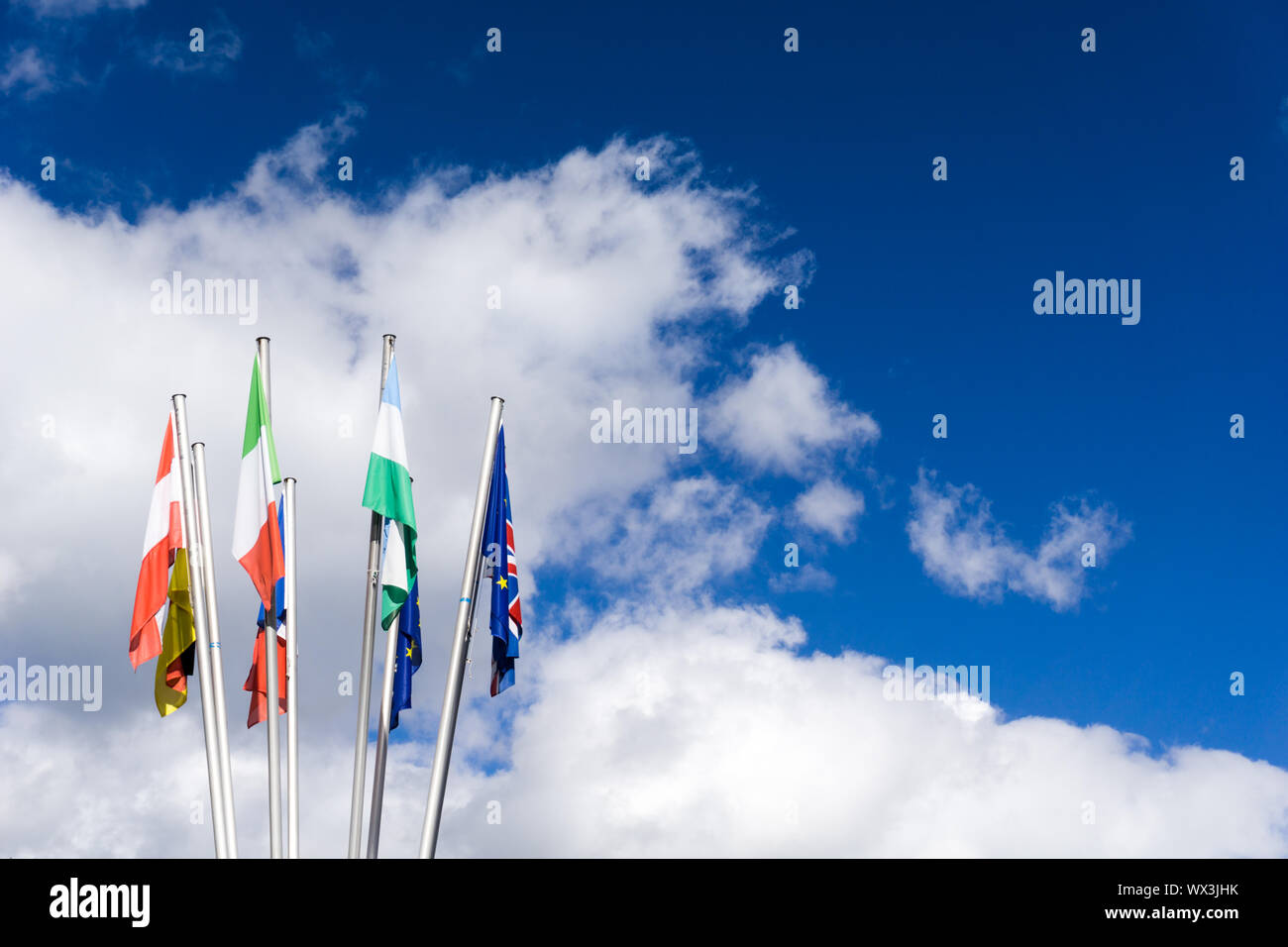 flags of the European Union under a blue sky with white clouds Stock ...