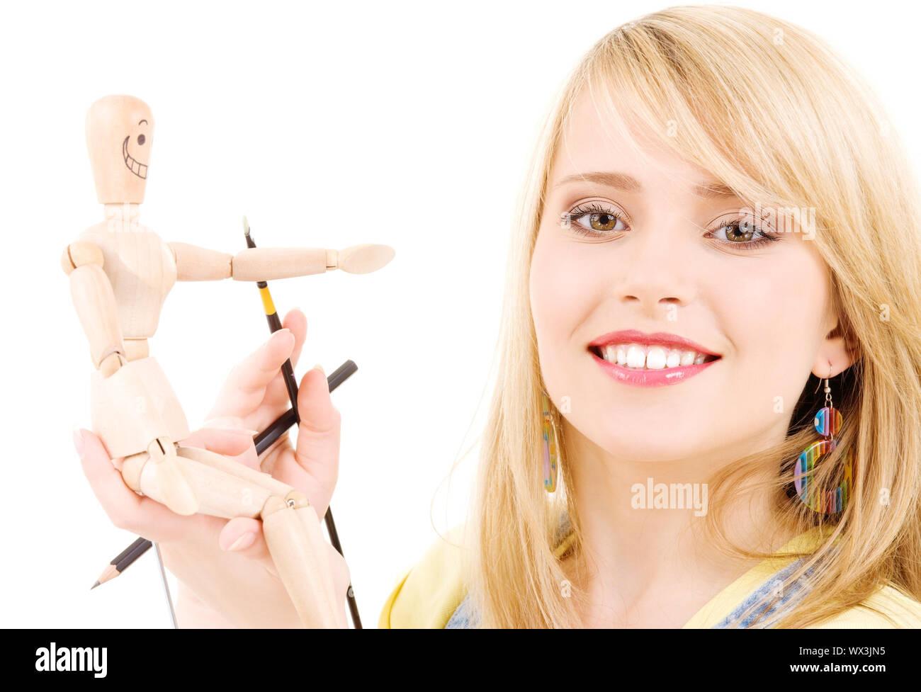 happy teenage girl with wooden model dummy over white Stock Photo - Alamy