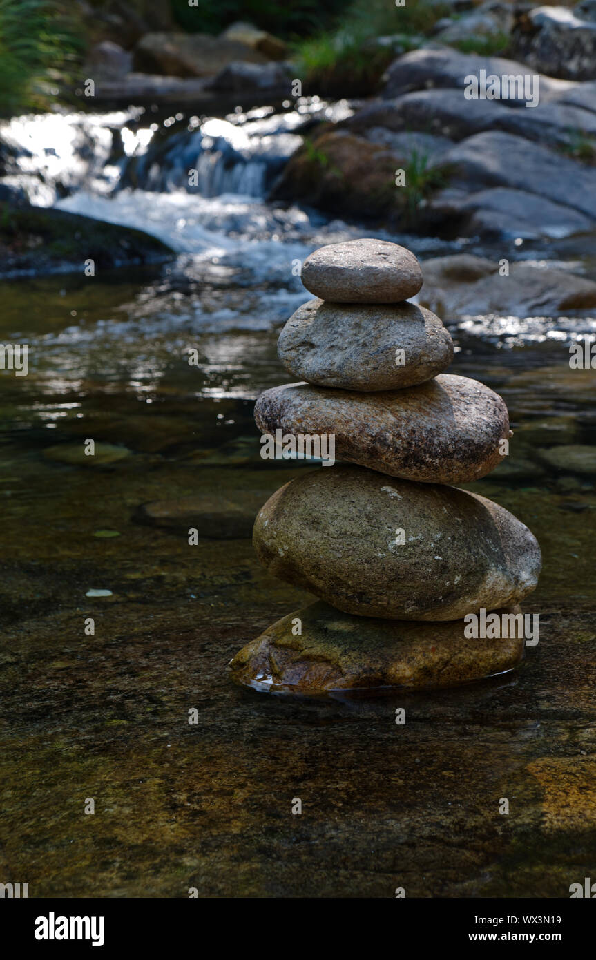 Zen rocks or pebble stack on river waters. Peaceful and spiritual theme ...