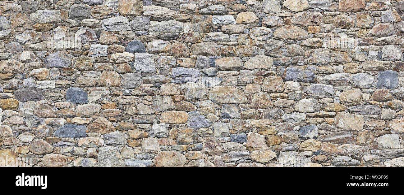 Rough stone wall in poster size Stock Photo - Alamy