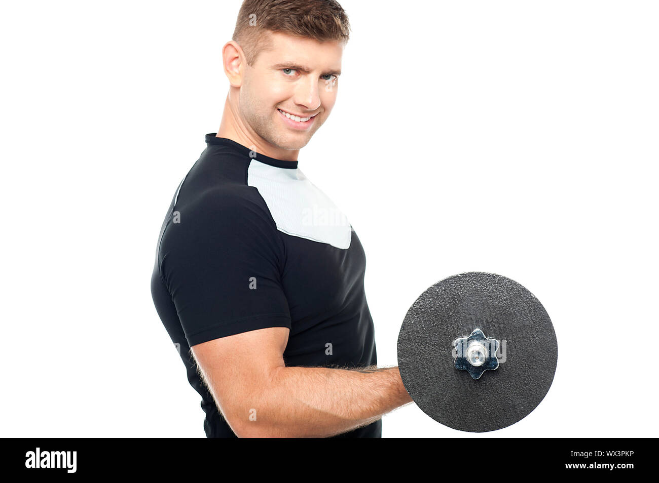 Side pose of gym instructor lifting weights. Toning his biceps Stock ...