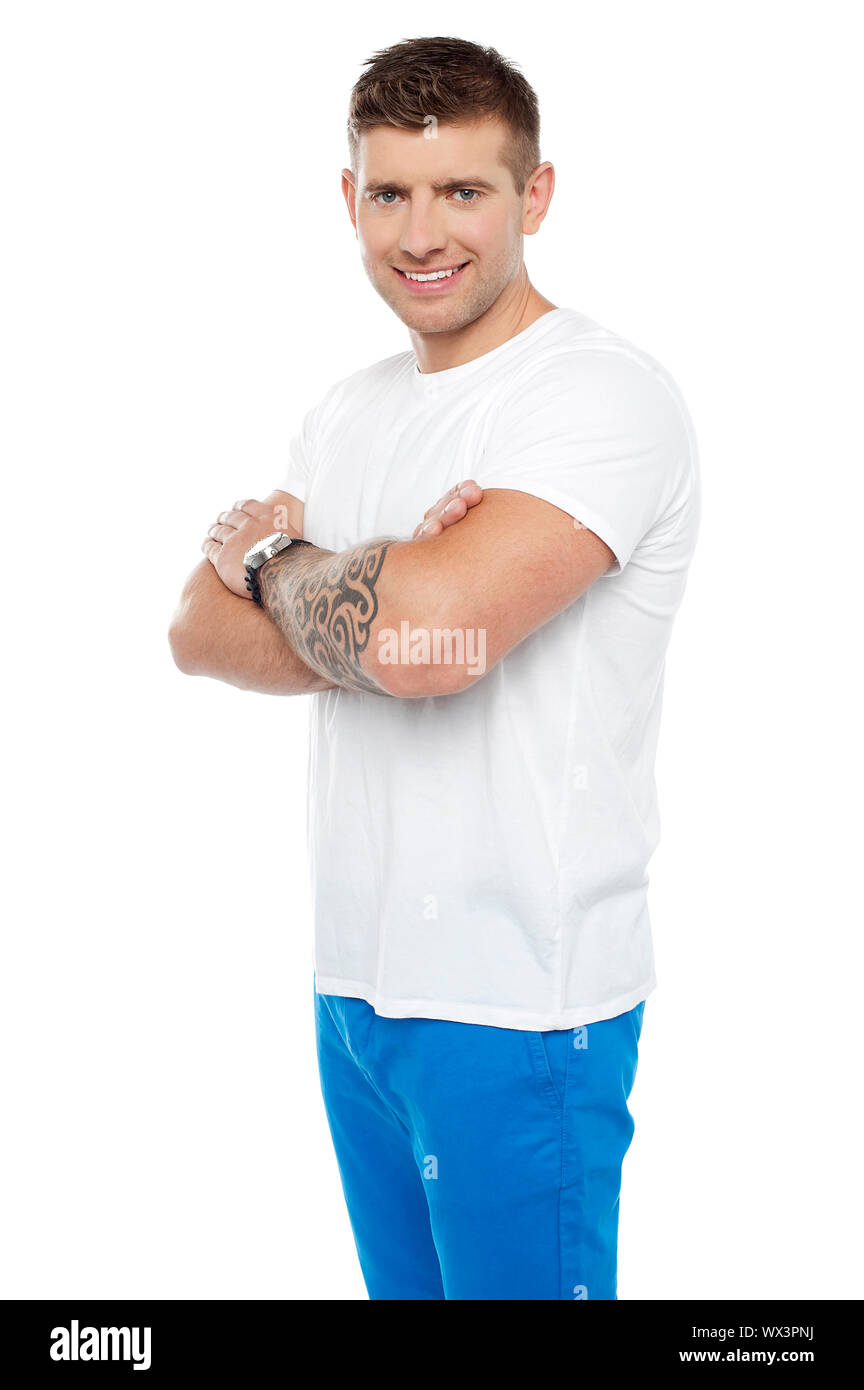 Smart young man posing with crossed arms. Tattoo on his hands Stock ...