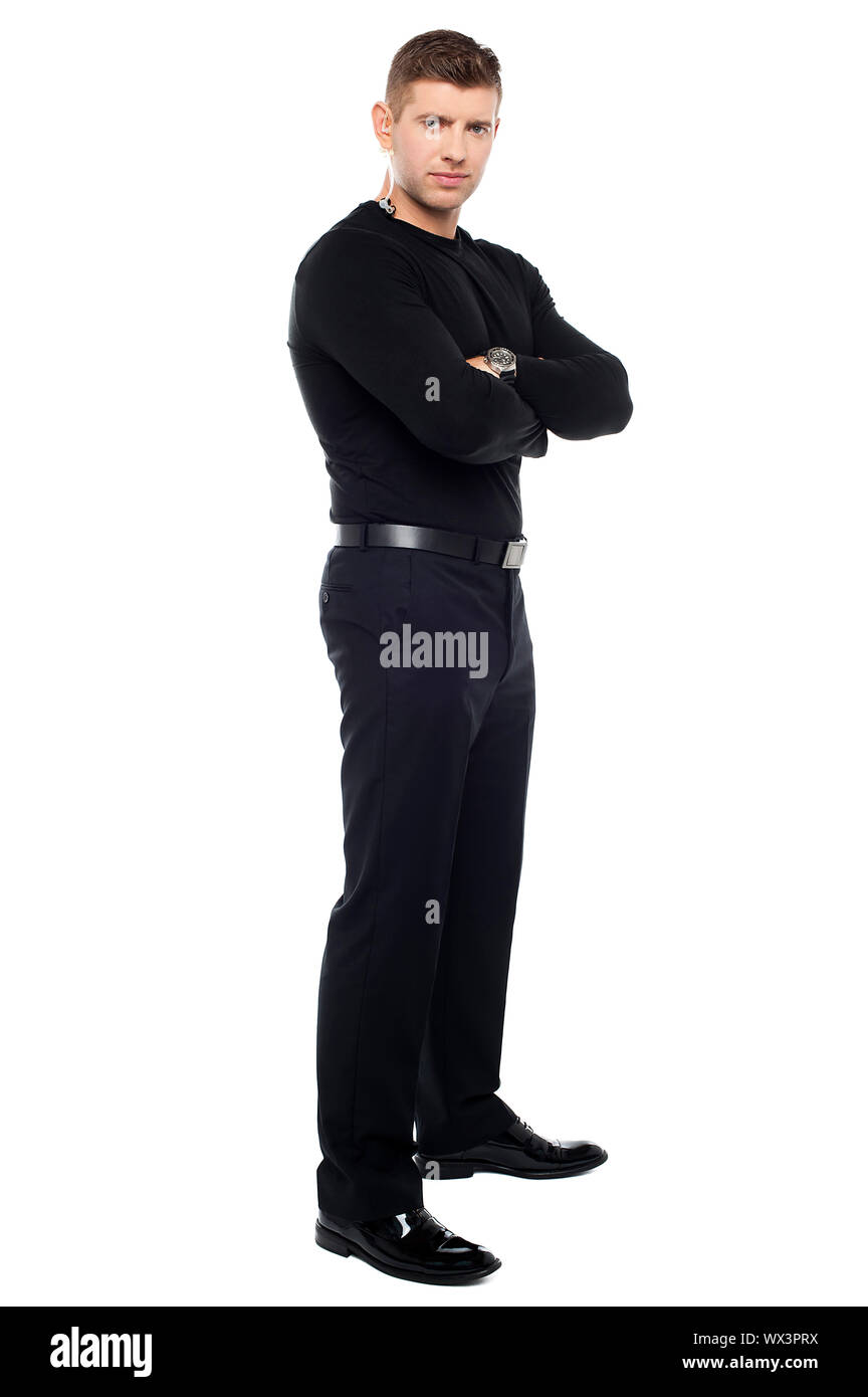 Handsome young bodyguard, full length portrait. Arms folded Stock Photo ...