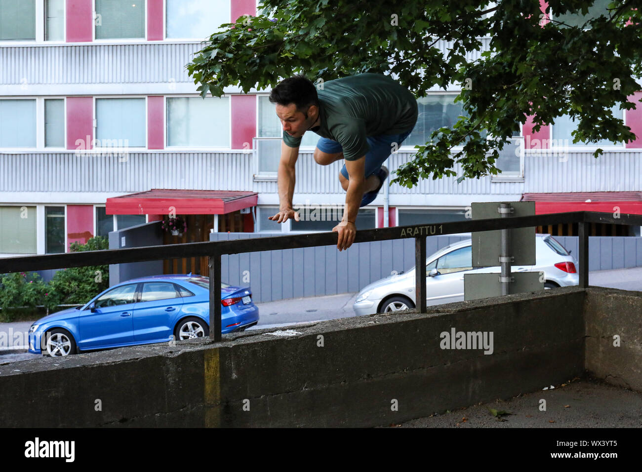 Parkour traceur performing a vault Stock Photo - Alamy