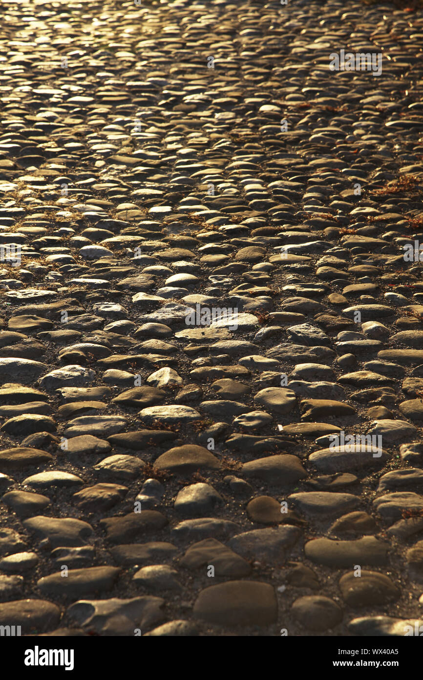medieval street pavement in the evening light Stock Photo - Alamy
