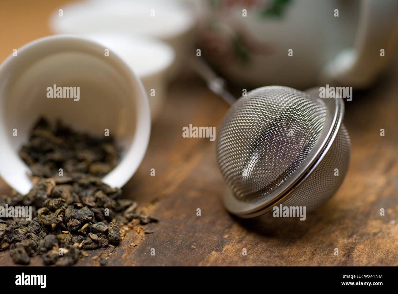 dry green chinese tea set,with strainer closeup,cups and teapot on ...