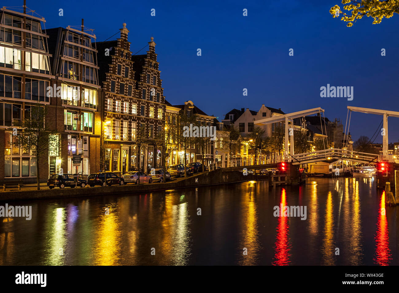 Buildings and bridge at twilight, Spaarne River, Haarlem, Netherlands ...