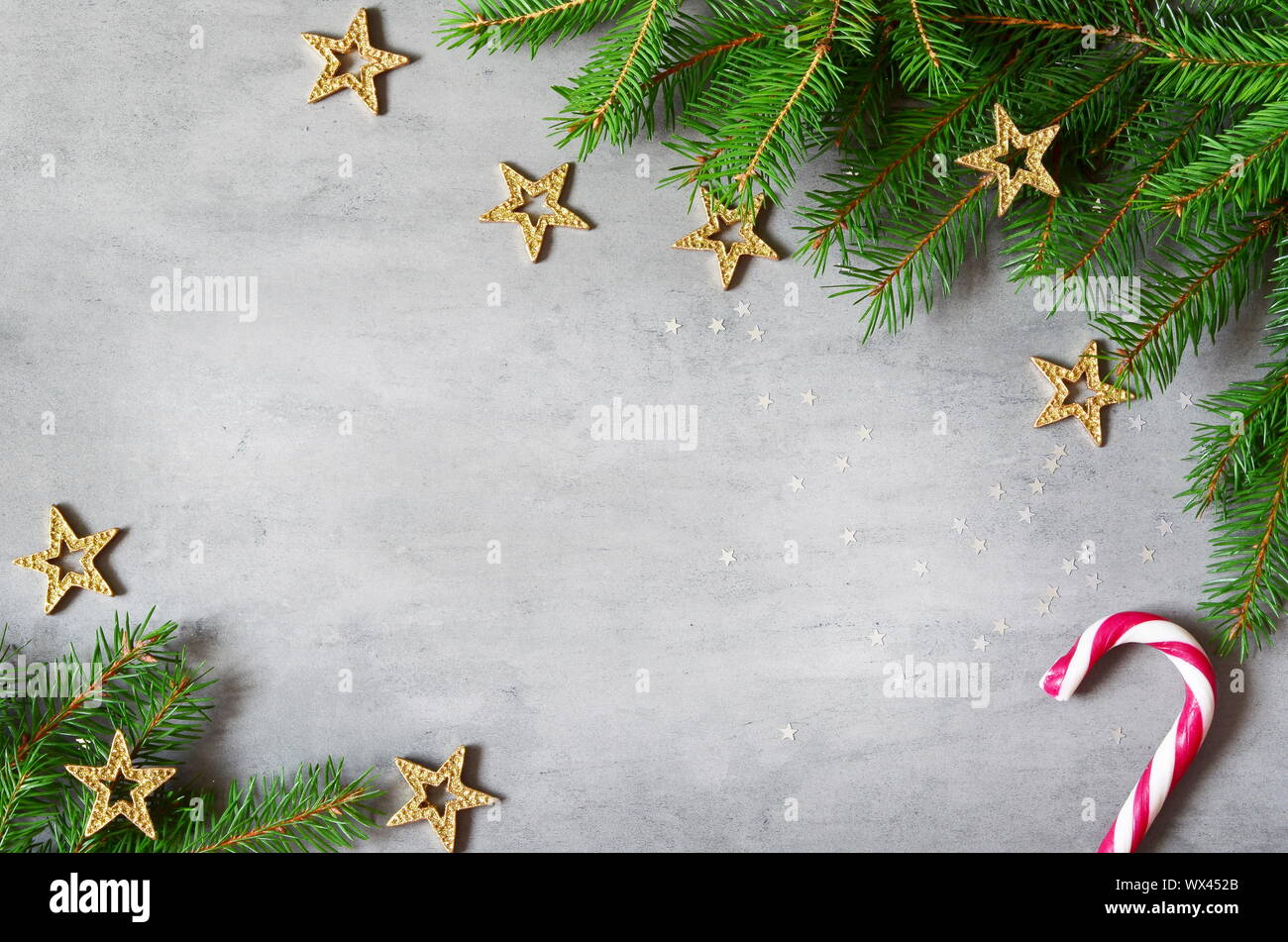 Christmas composition. Christmas candy cane, golden star and fir tree branches. Top view, flat ...