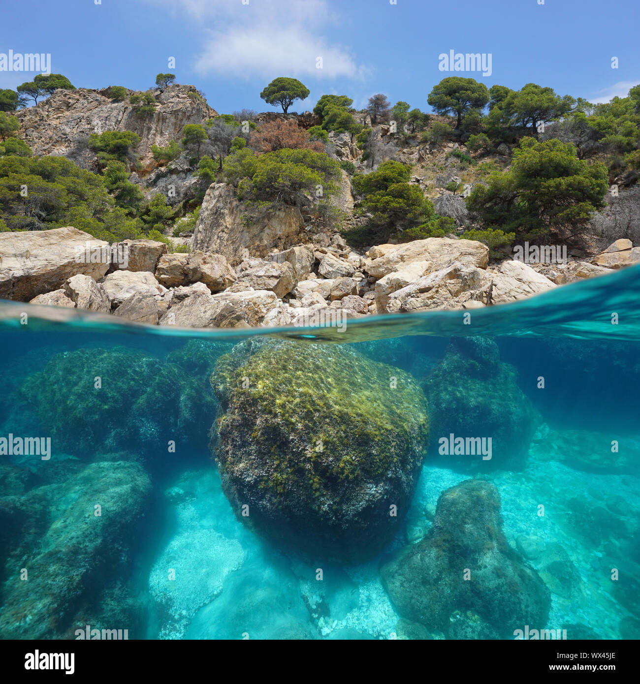 Mediterranean sea rocky coast with rocks underwater, split view above ...
