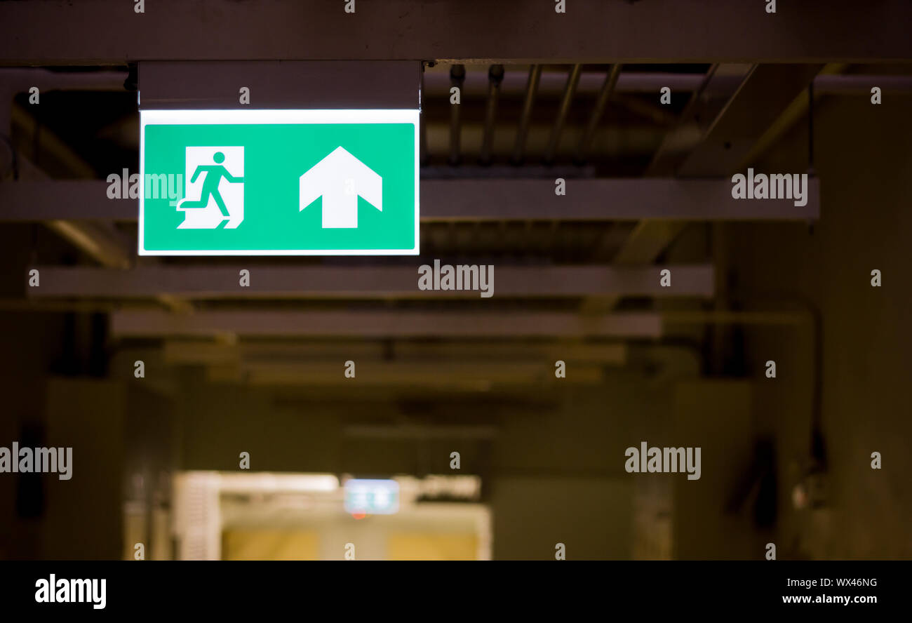 Green emergency exit sign leading to the Fire Exit with emergency light ...