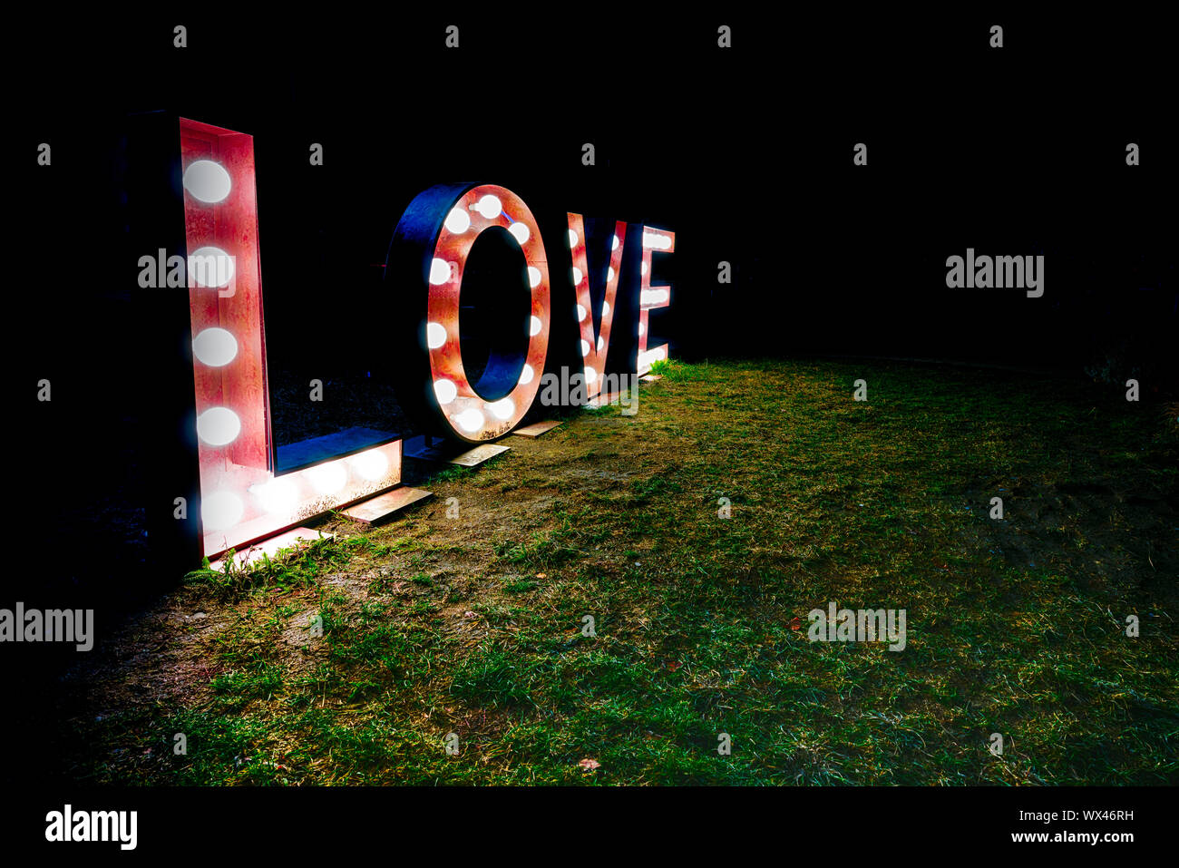 black night with the word and text love written in brightly lit letters ...