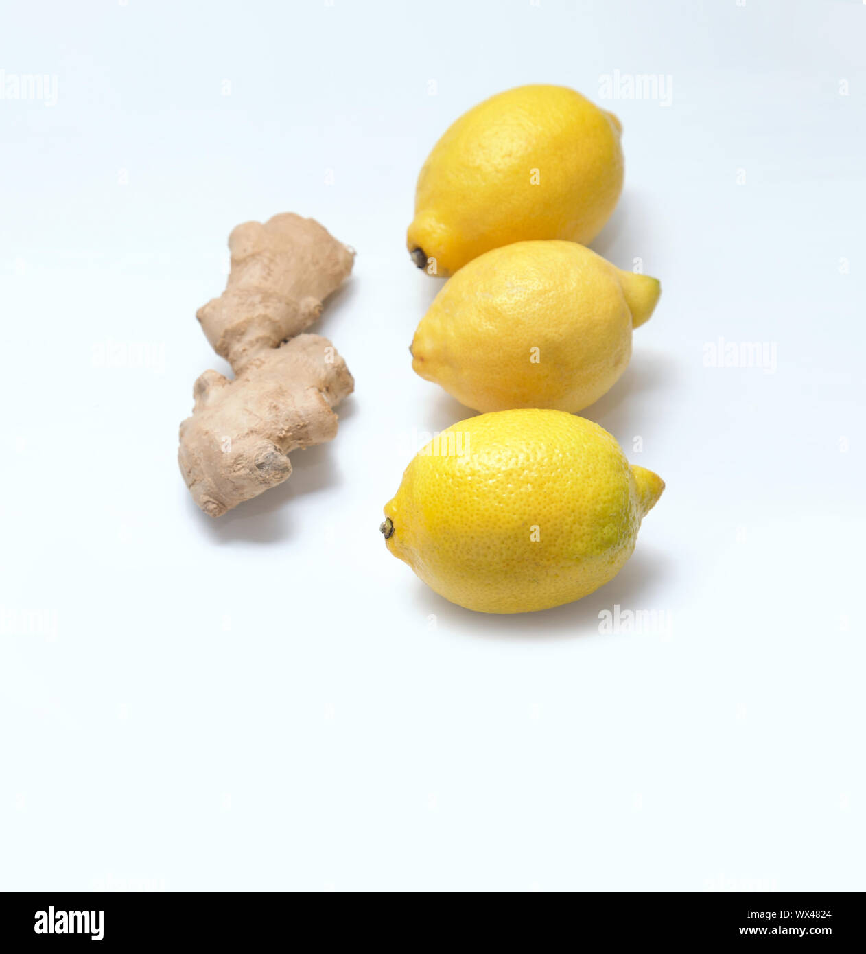 Three yellow lemons and ginger root on a light background Stock Photo ...