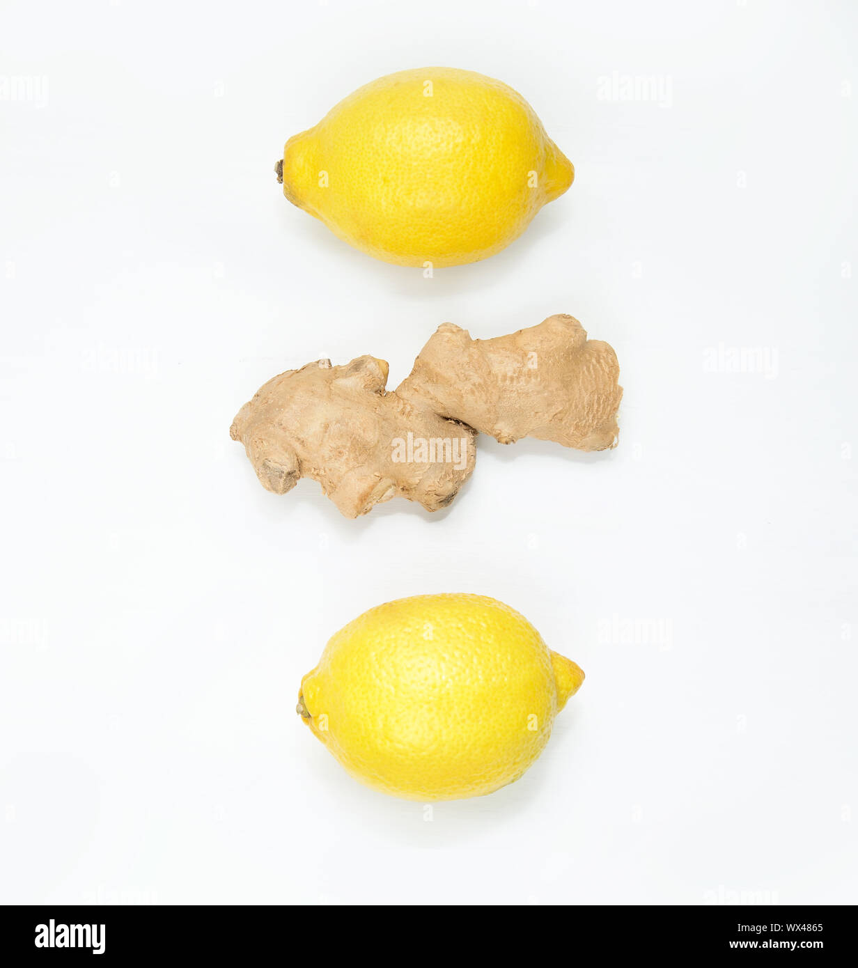 Fresh lemons and ginger root on a light background Stock Photo - Alamy