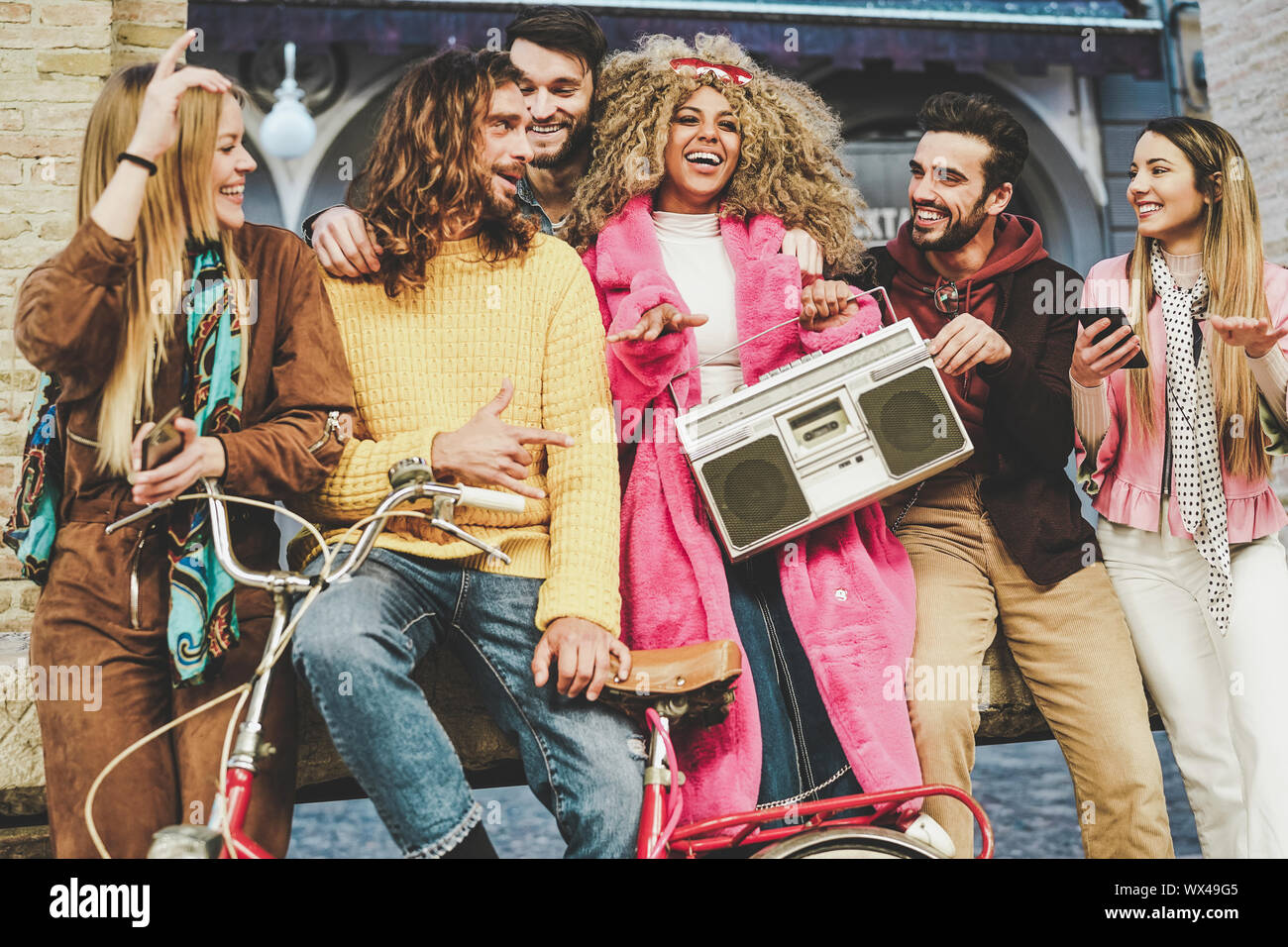 Group of friends making party listening to music with vintage boombox ...