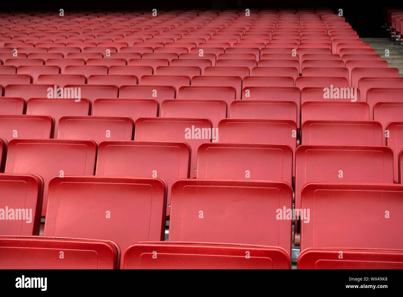 Red seat row in stadium Stock Photo - Alamy