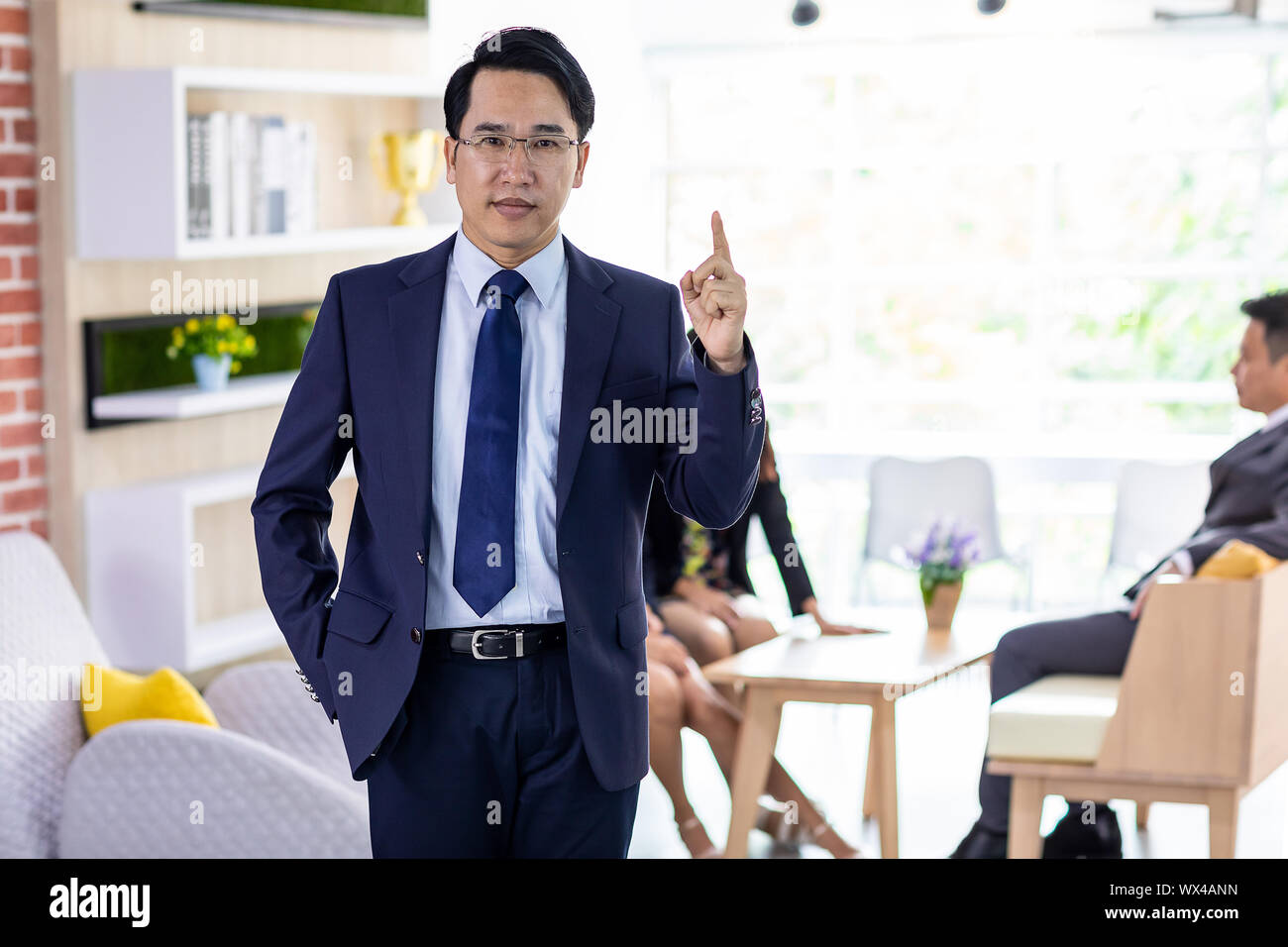 asian businessman point finger up Stock Photo - Alamy