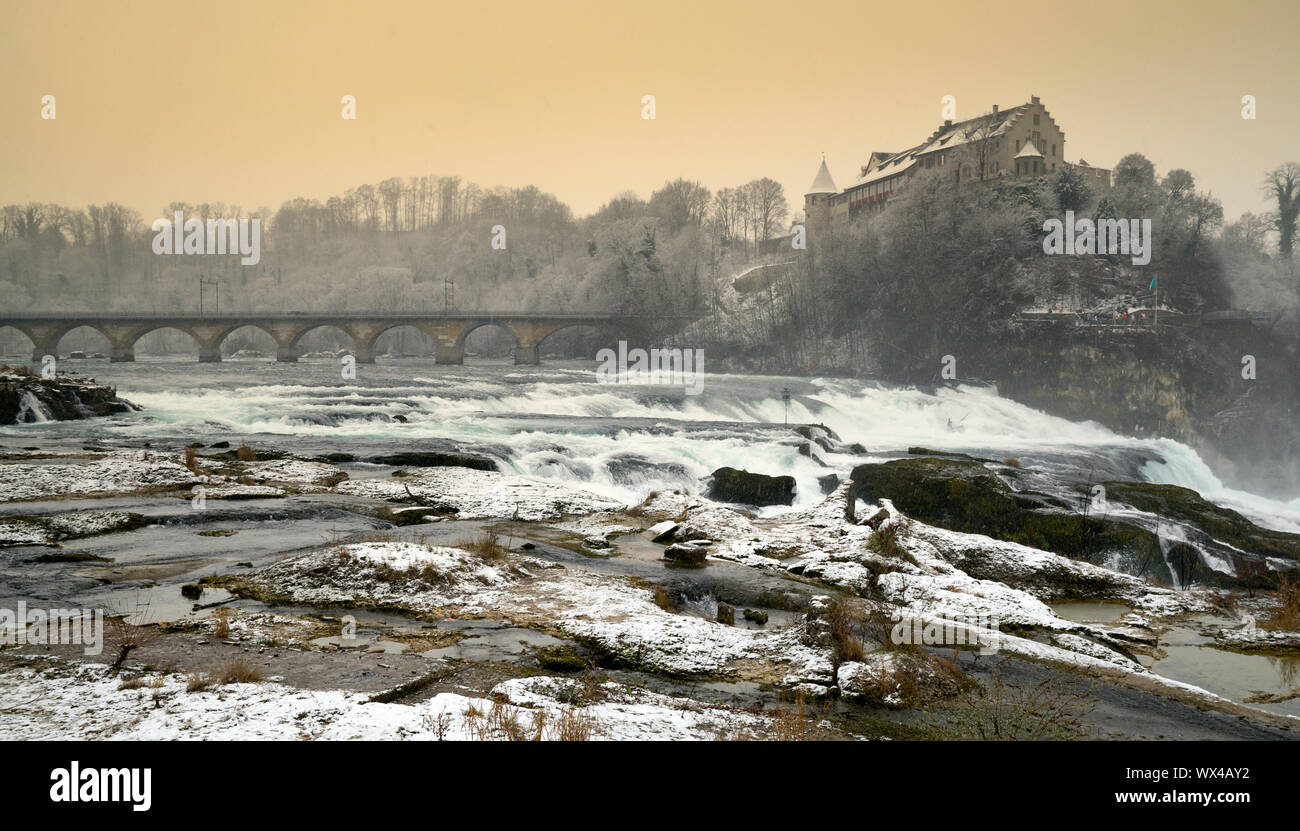 Rhine Falls in Switzerland on a winter evening with snow falling Stock ...