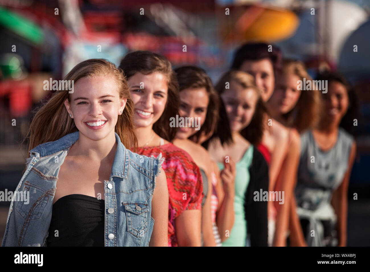 Group of eight girlfriends in a row smiling Stock Photo - Alamy