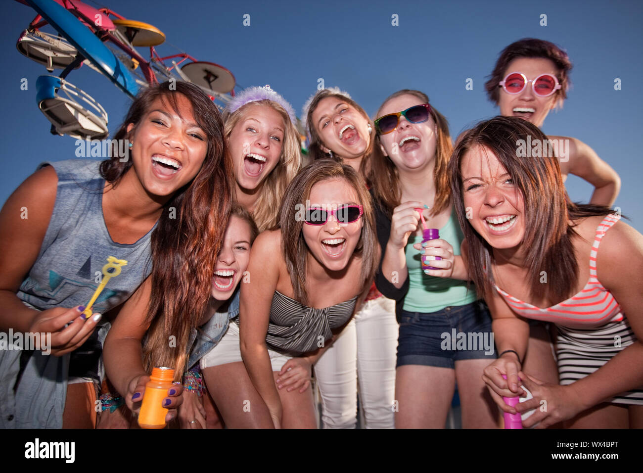 Group of happy girls with bubbles at amusement park Stock Photo - Alamy