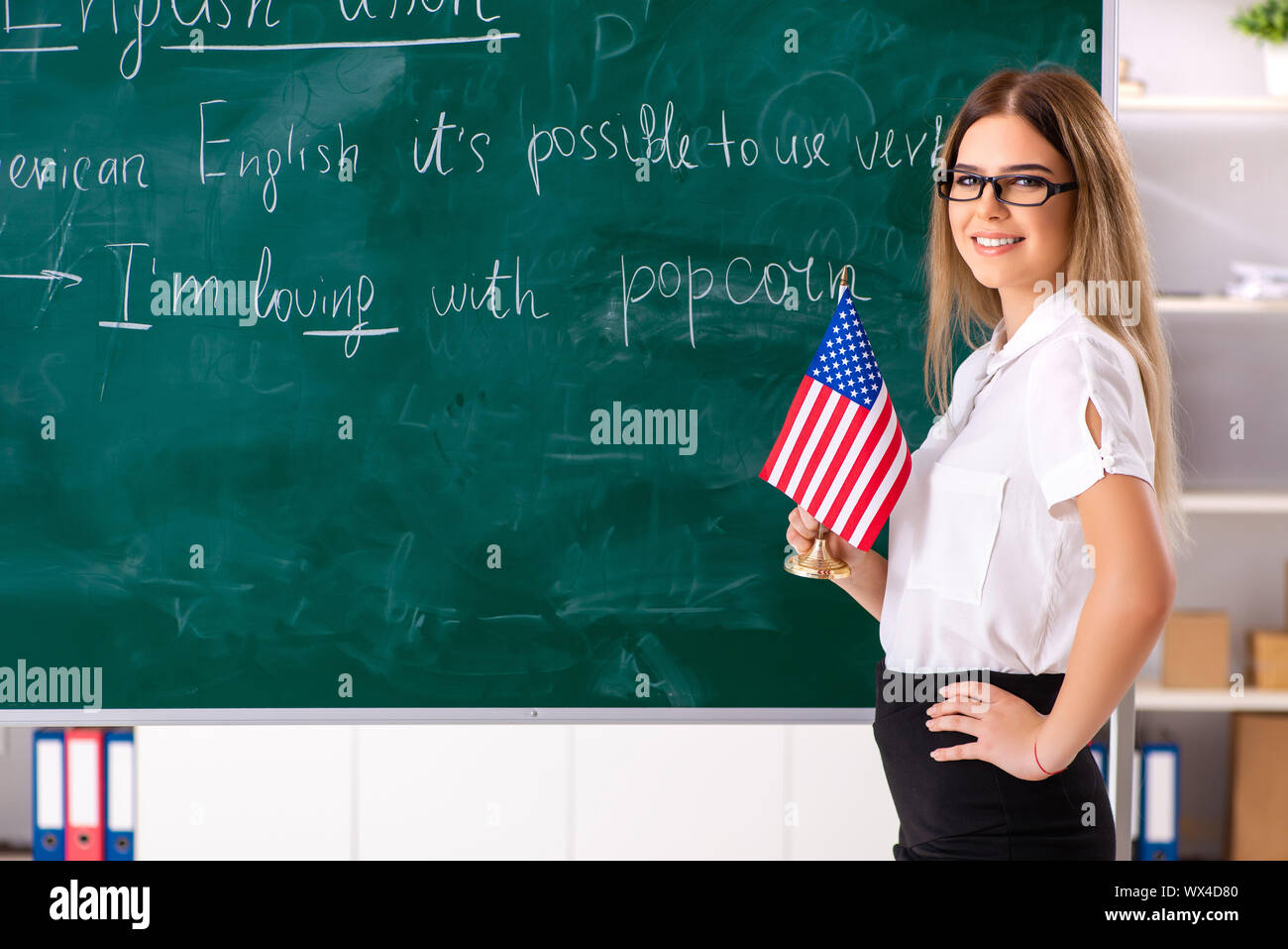Young female english language teacher standing in front of the b Stock ...