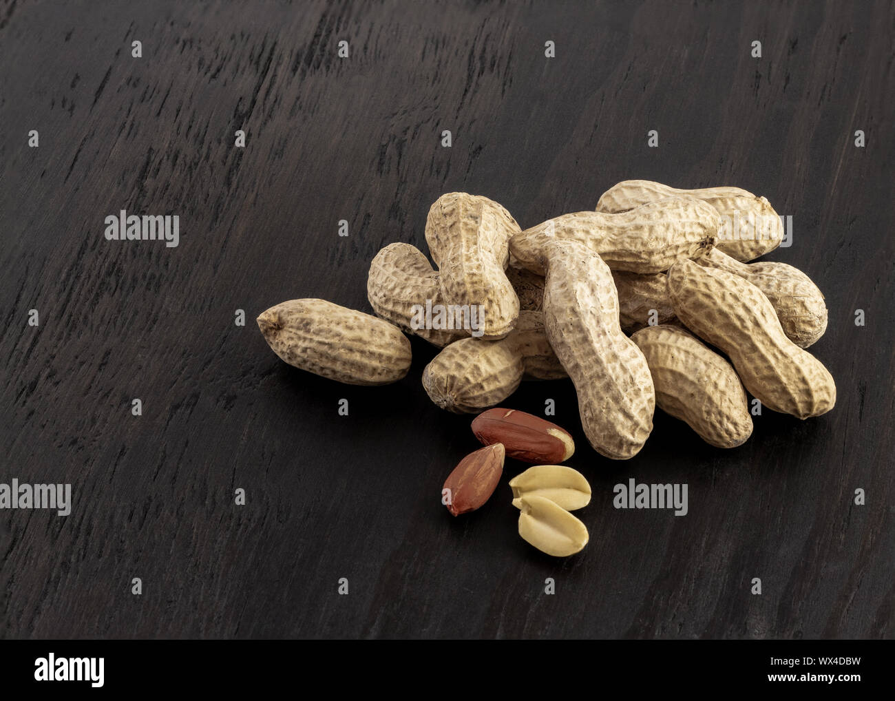 a group of shelled peanuts on wood background Stock Photo - Alamy