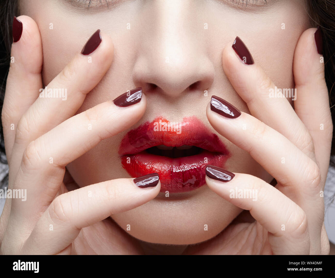 Brunette girl with unusual alyapy red female face makeup Stock Photo ...
