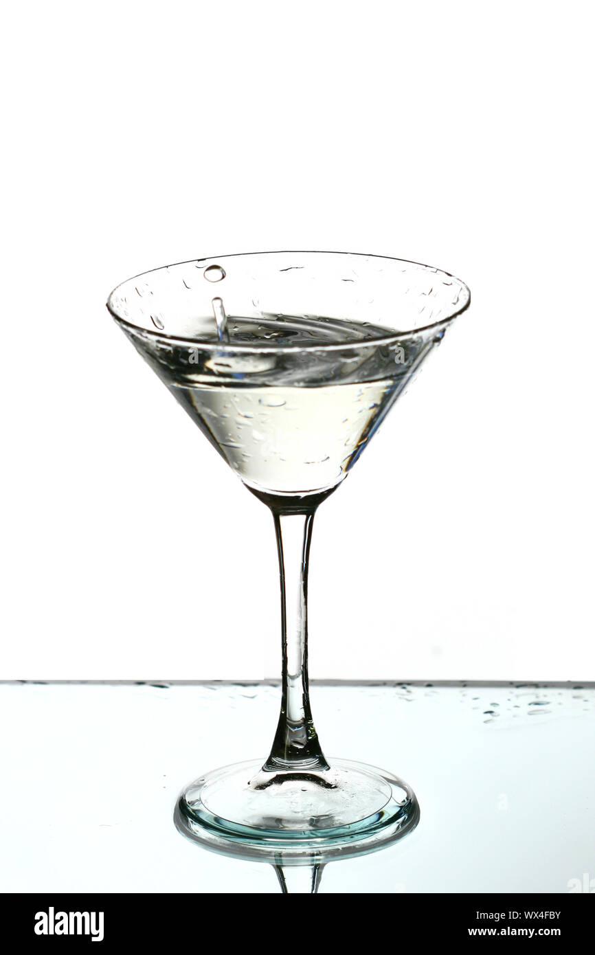 martini splash on white bar background Stock Photo - Alamy