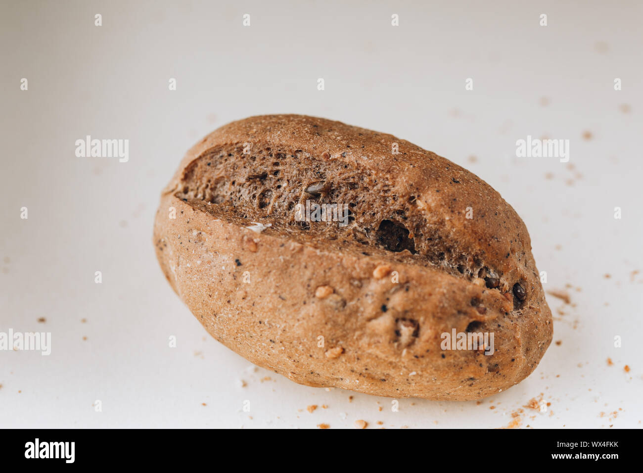Rye bun with sunflower seeds and nuts on a light background Stock Photo ...