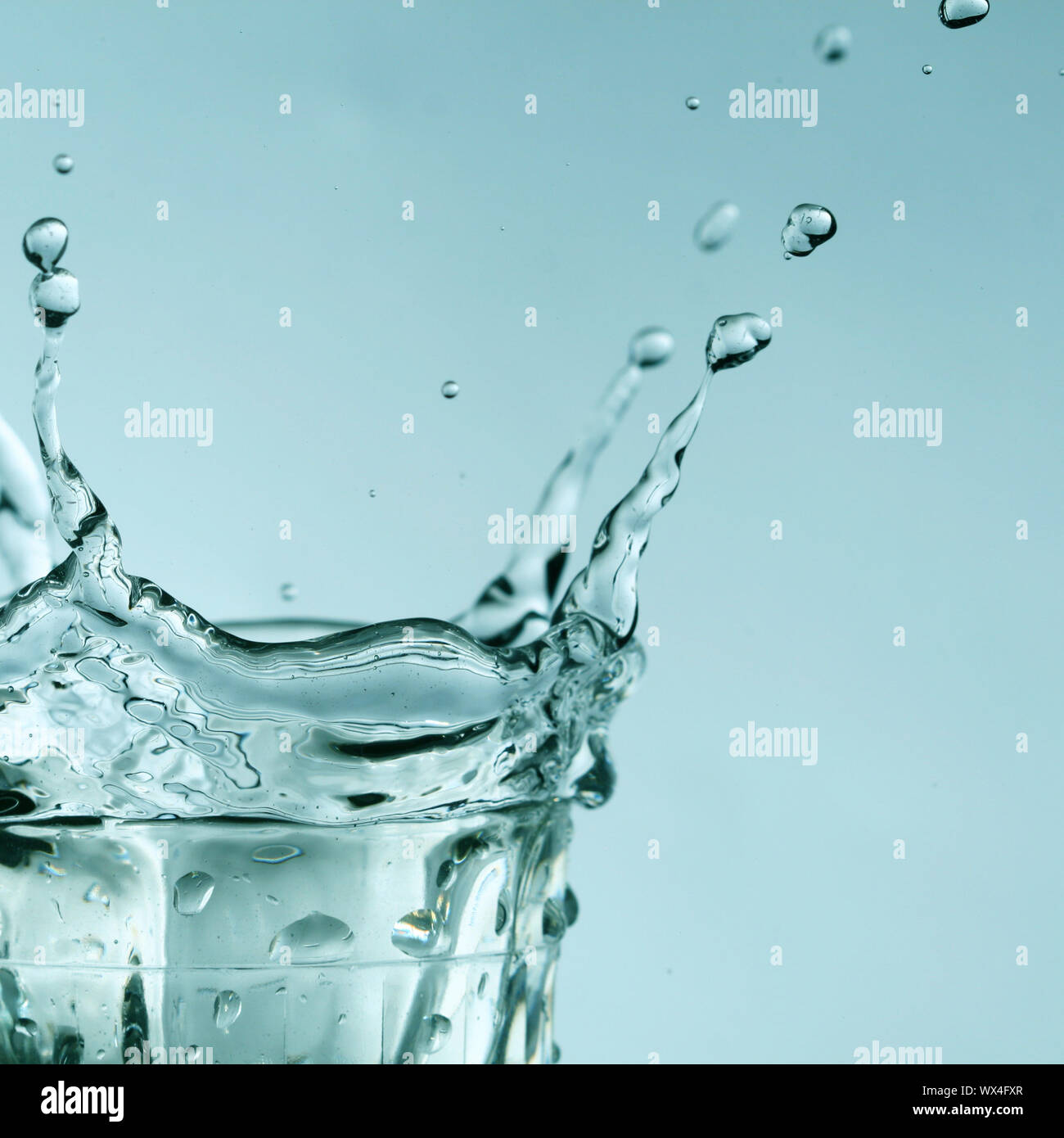 super splash in glass on white background Stock Photo - Alamy