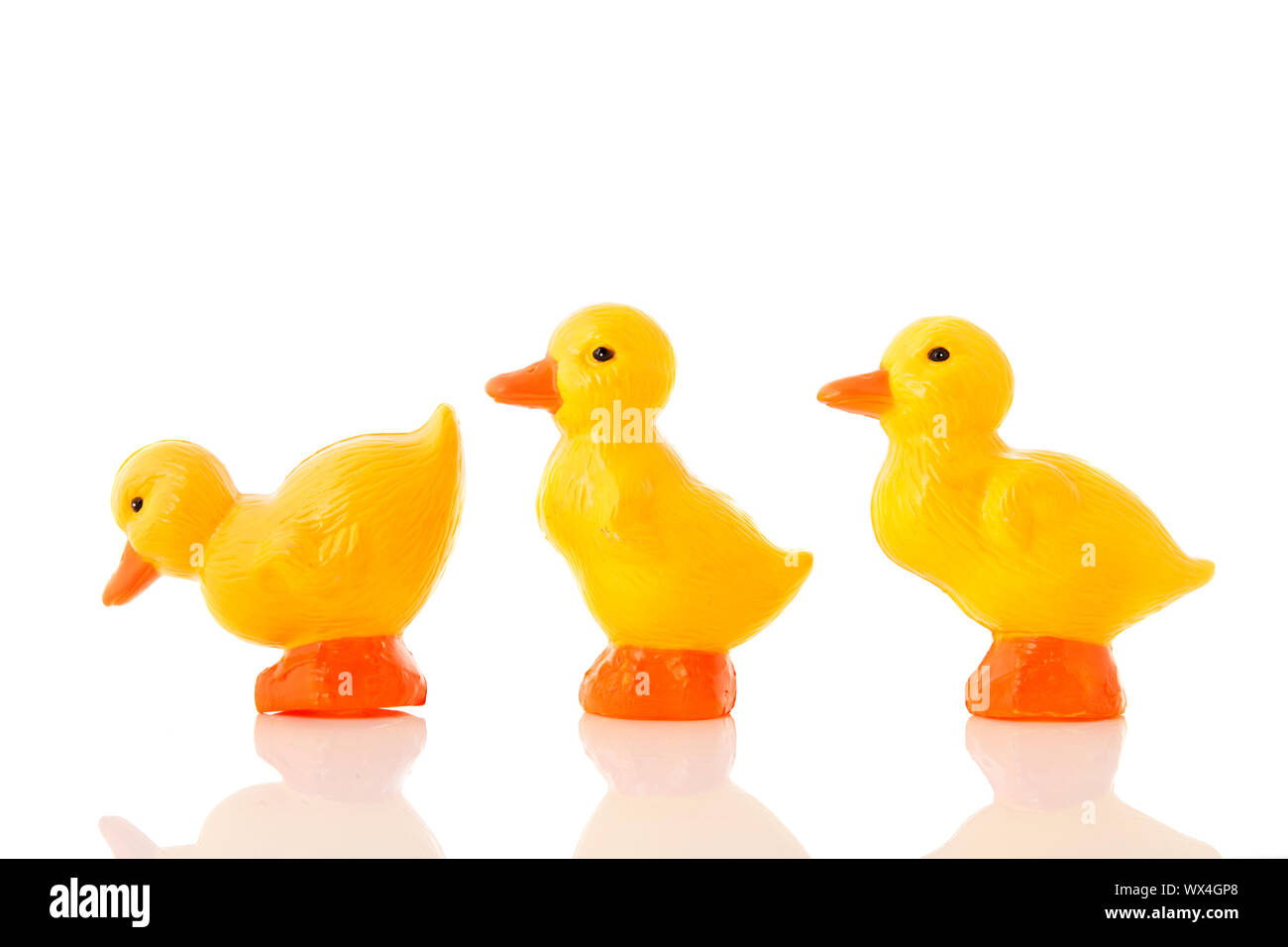 Row plastic toy ducks isolated over white background Stock Photo - Alamy