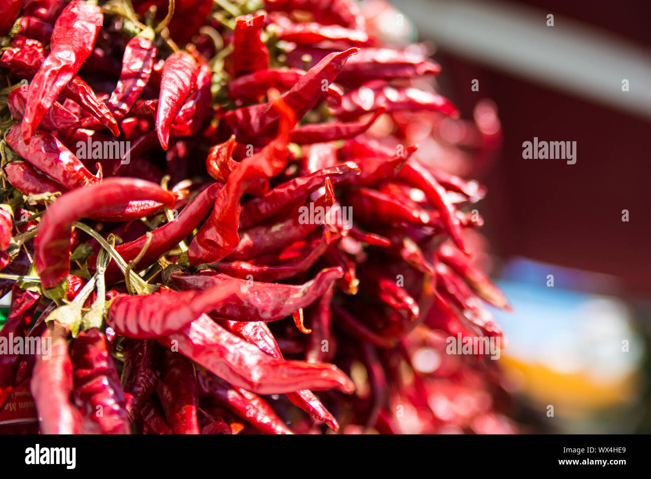 Dried red chilli paprika on a market stall with out of focus areas on ...