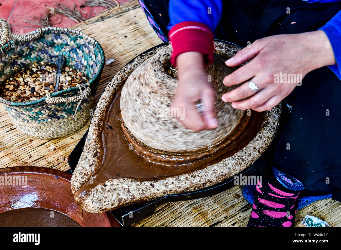 Argan oil extraction by traditional stone handmill mill Stock Photo - Alamy