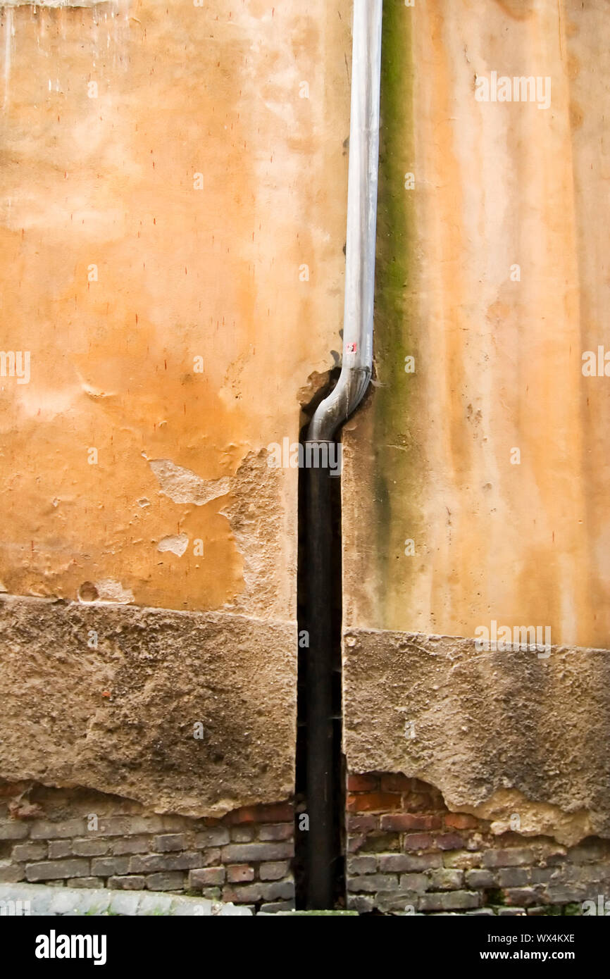 Drain pipe and aged wall surface texture image. Taken in the old town ...