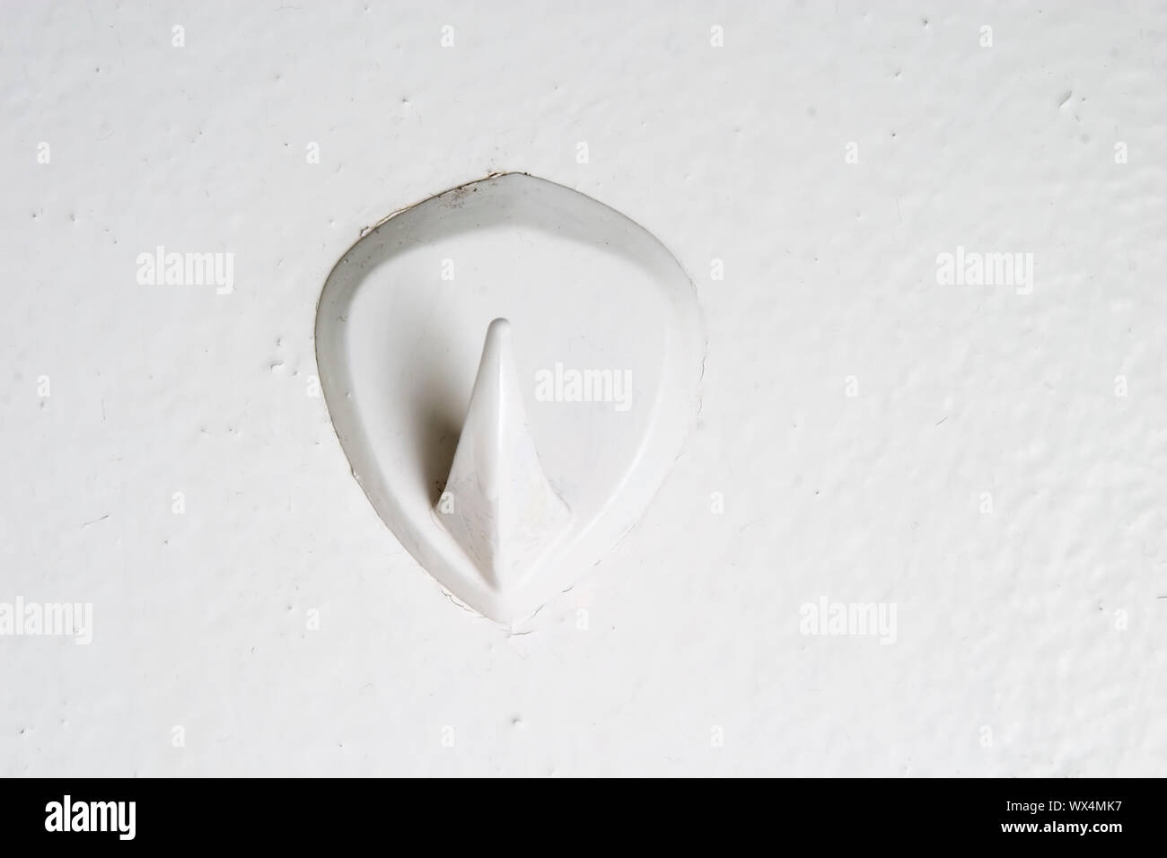 A retro bathroom hook stuck on the wall from the 1970's era Stock Photo ...